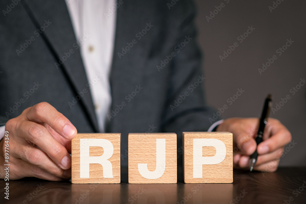 There is wood cube with the word RJP. It is an abbreviation for ...