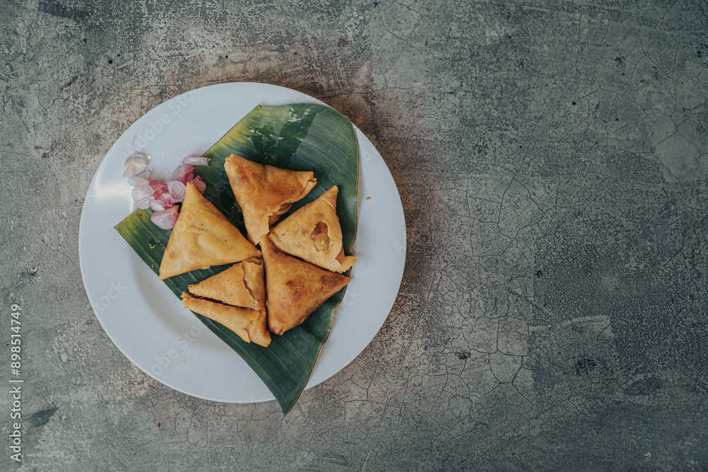 Fried Samosa. Popular Indian traditional snacks on a white plate with ...