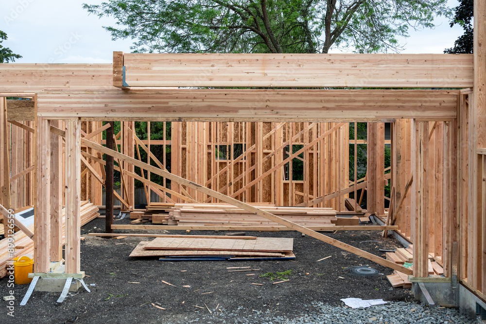 New house construction job site, wall wood framing started and glue ...