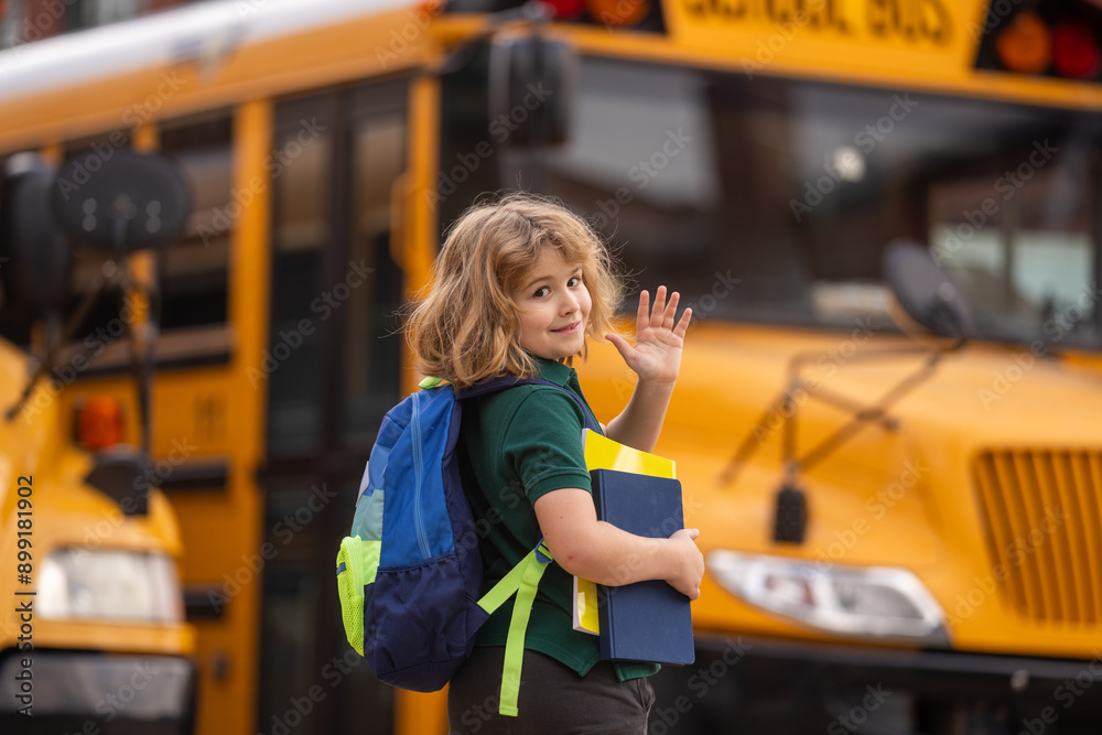 Schoolboy getting on the school bus. American School. Back to school ...