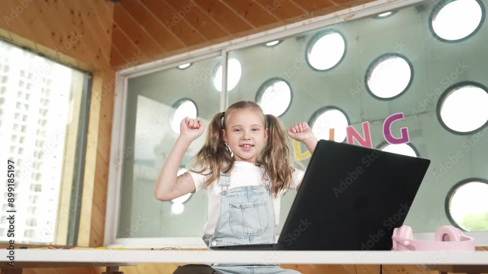 Happy girl looking at laptop screen while raised hands to celebrate ...
