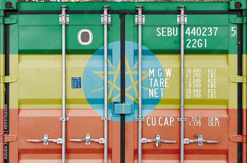 Ethiopia flag depicted on metal doors of shipping cargo container outdoors in docks area close ...