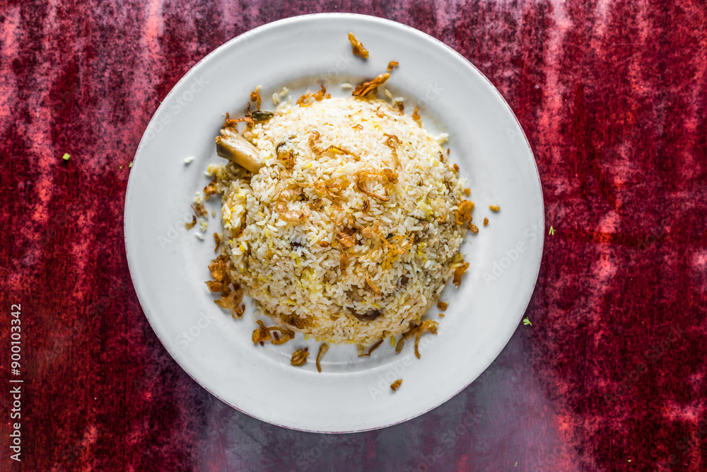 Chicken Kacchi Biryani or biriyani rice with fried onion served in ...