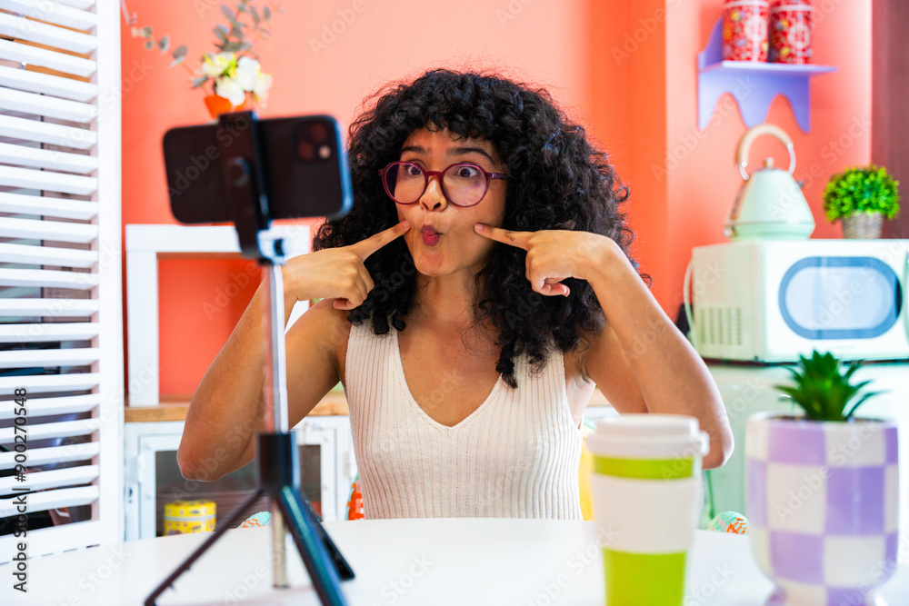 Beautiful young hispanic woman with curly hair portrait at home - Happy ...