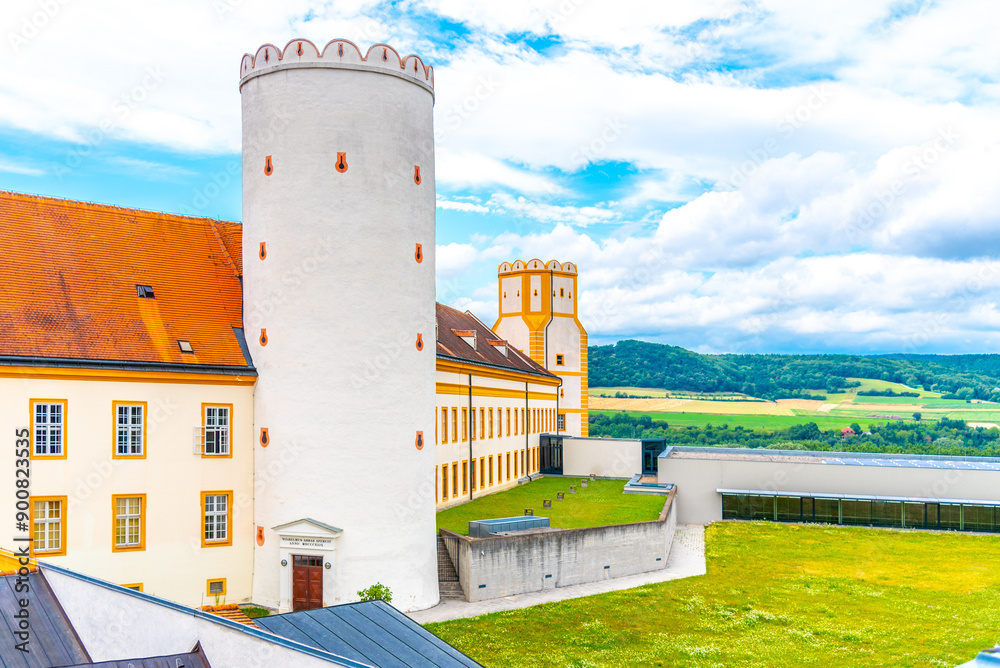 A vibrant view of Melk Abbey with its iconic yellow facade and circular ...