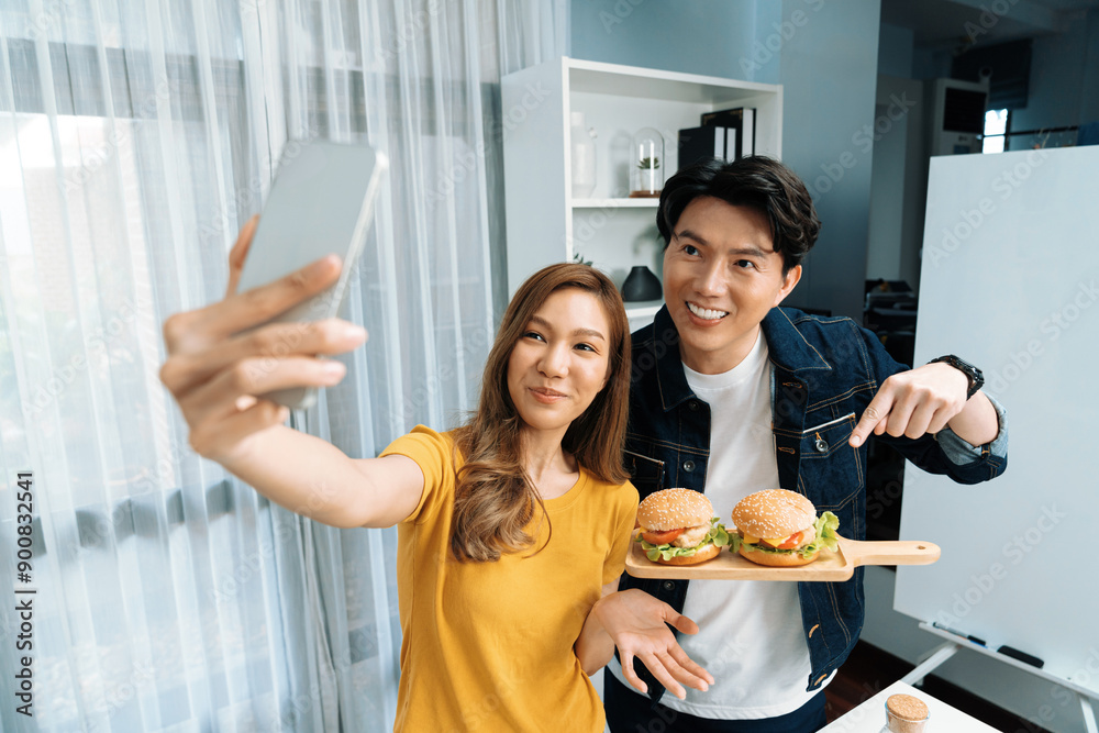 Smiling host chef influencers taking photo with smartphone by selfie ...