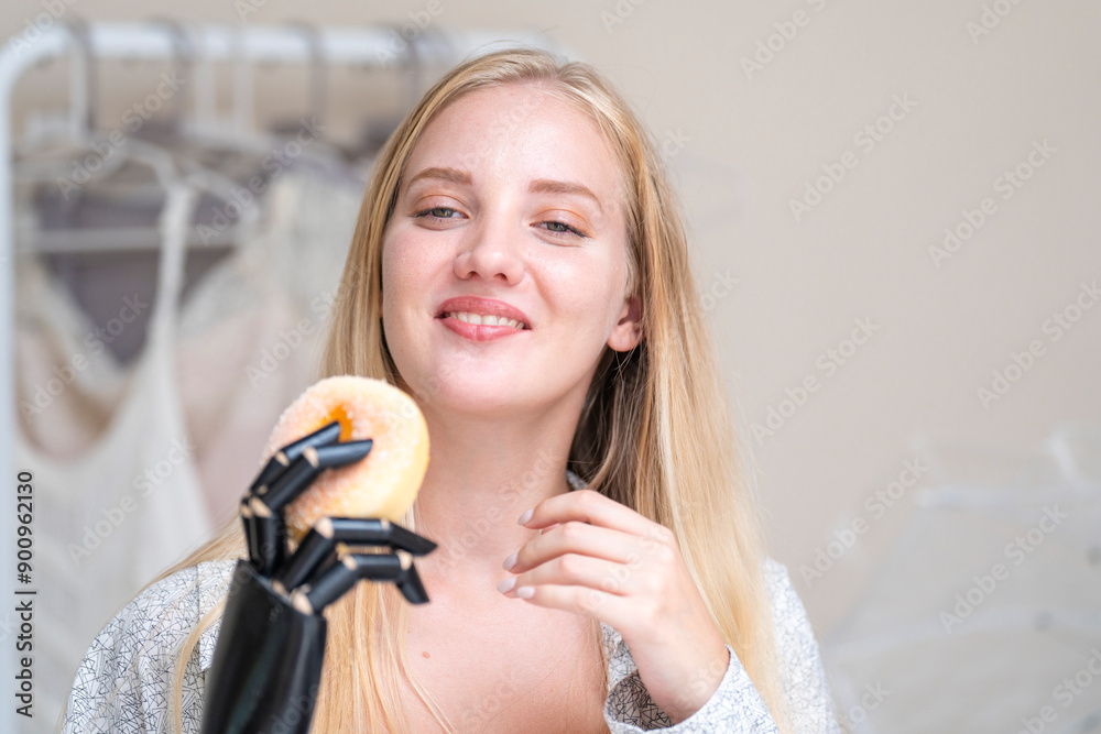 A young woman is using a robotic prosthetic arm attached to her body ...
