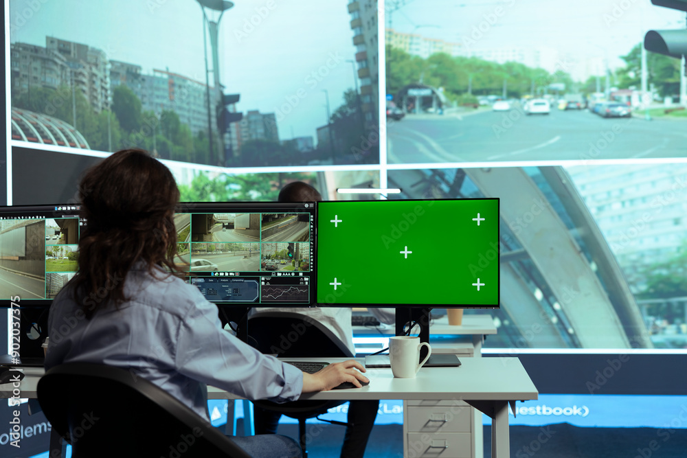Woman employee monitoring traffic via surveillance radar footage, using ...