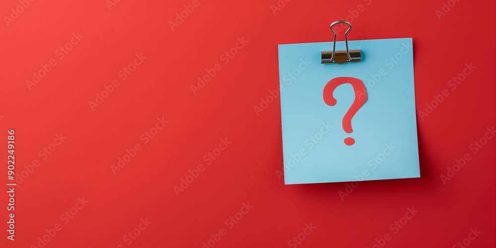 Big red question mark hanging on blue sticky note with paperclip on red ...