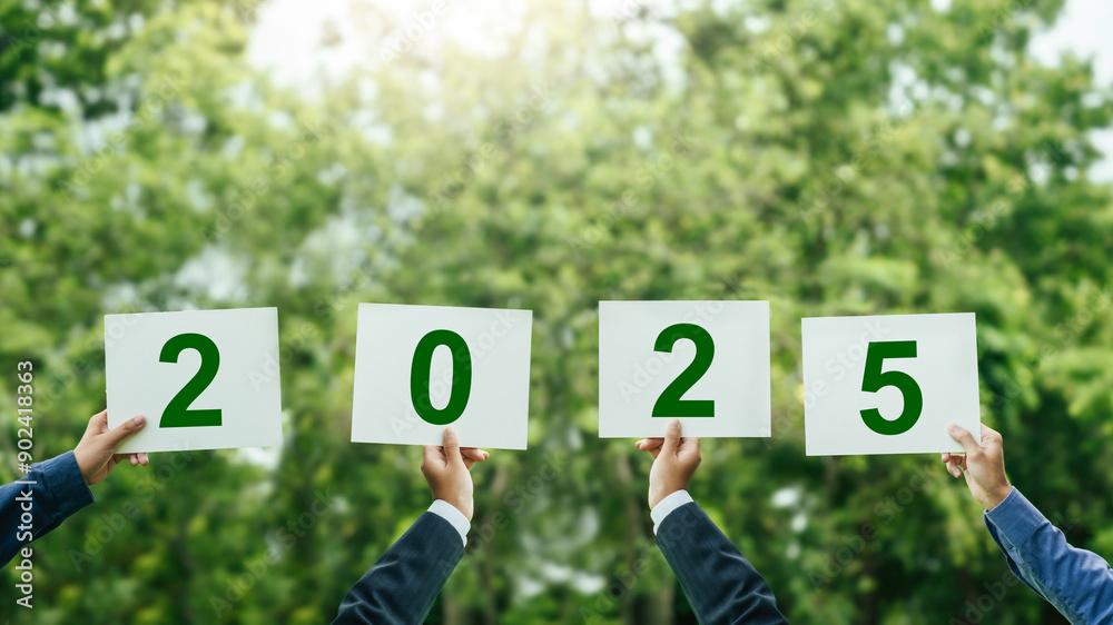 Businessman hands holding up the year 2025 with Nature background. 2025 ...