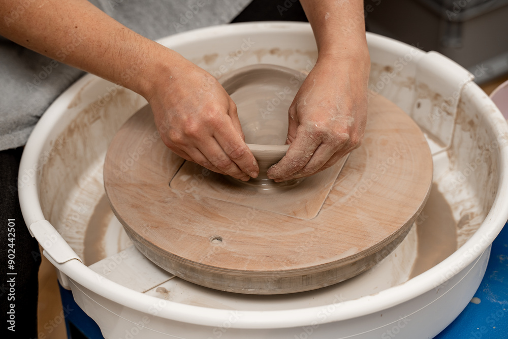Wheel throwing. Learning how to model clay into different shapes with ...