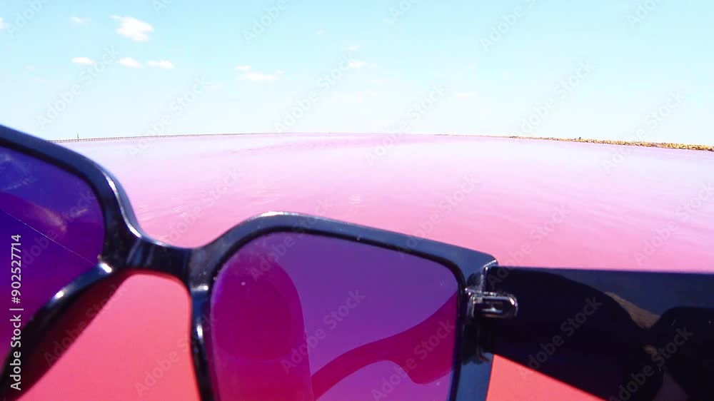 Pink lake, top view. beautiful girl in swimsuit lies on the water of ...