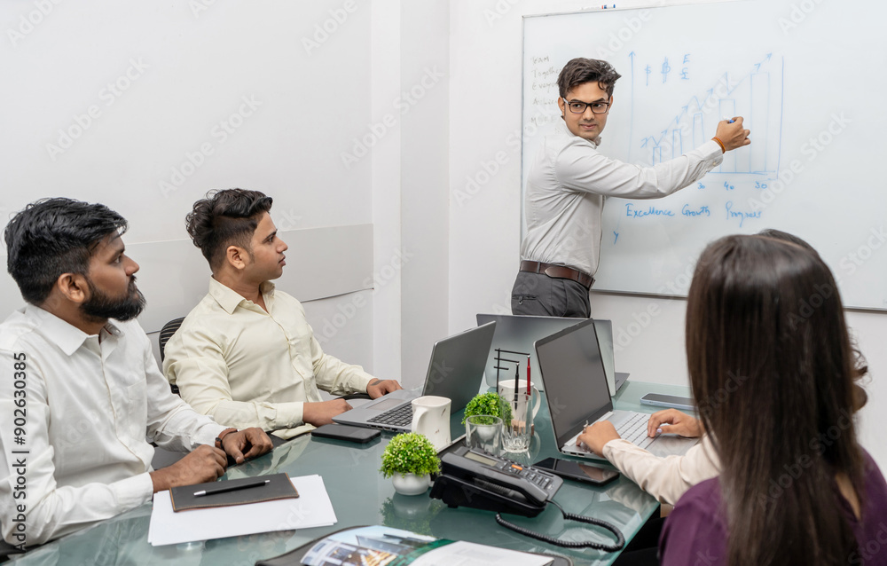 Team leader presenting financial stats reporting during group meeting ...
