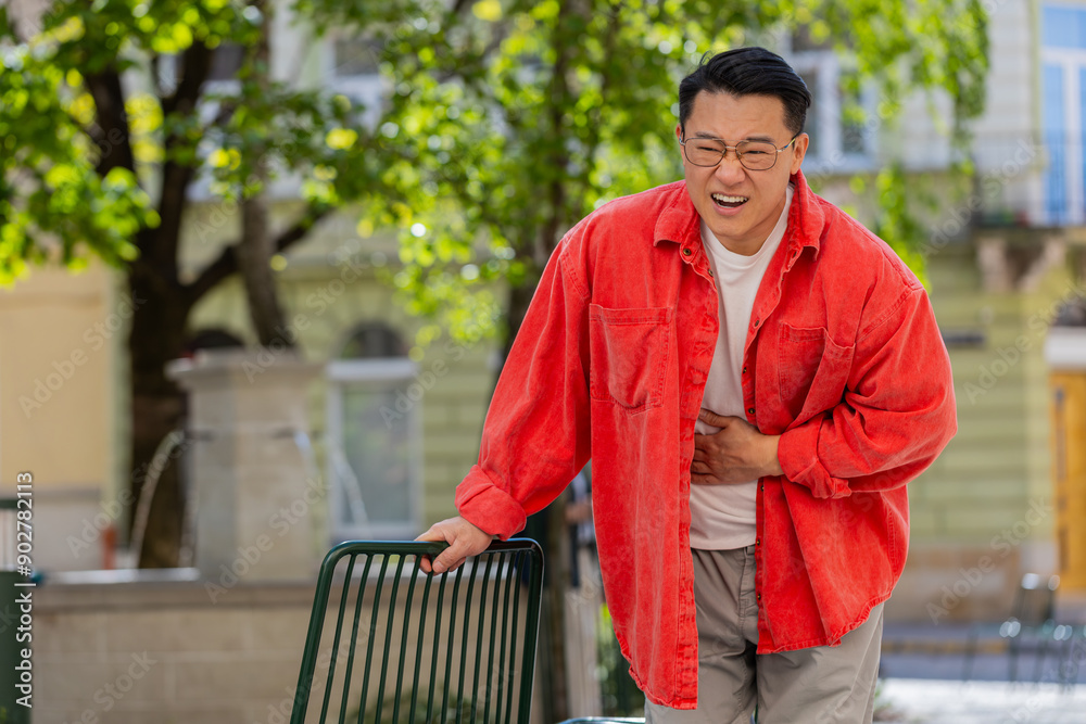 Asian middle-aged man feeling sudden strong abdominal stomach ache ...