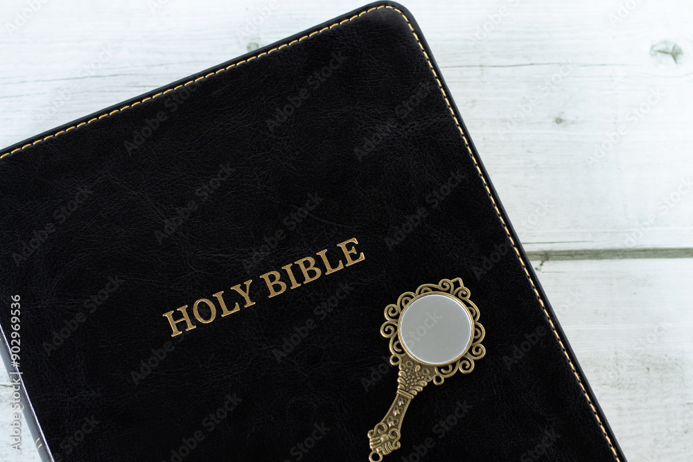 Holy bible book and antique mirror on wooden table. Top view. Biblical ...