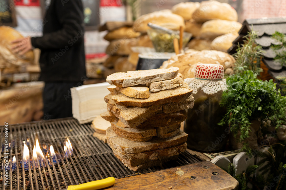 Fresh bread is sold in a shop at the fair. Person selling traditional ...