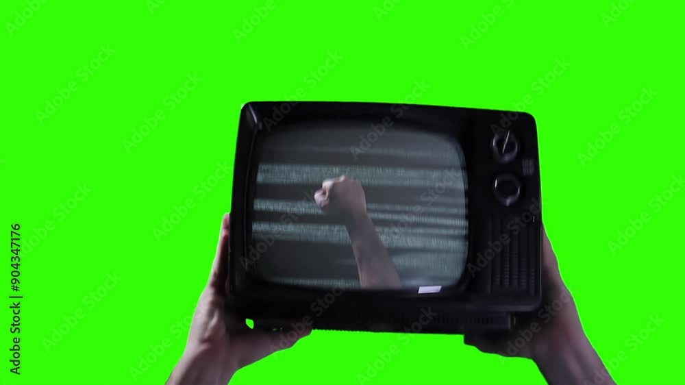 Hands Lifting Old TV with Fist on Screen Against Green Background. You ...