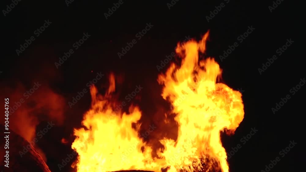 A dramatic image of a fierce fire burning intensely against the dark ...