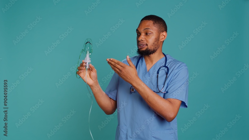Male nurse doing medical instruction video on how to use handheld ...