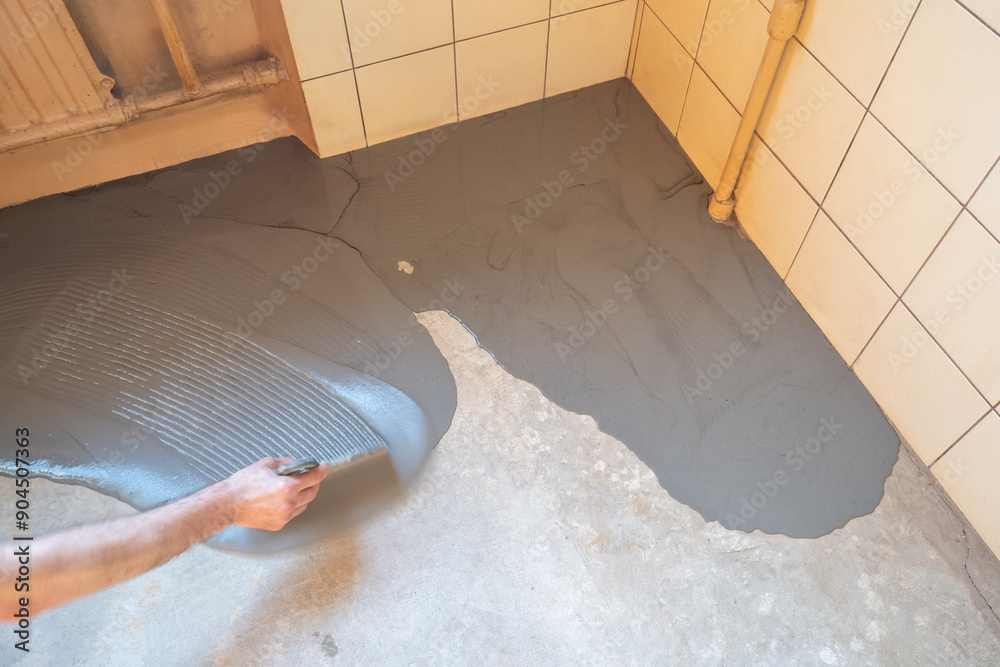 Applying concrete coating to floor. Creation of concrete screed ...