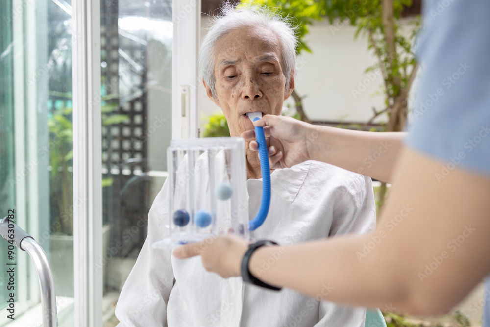 Female caregiver holding spirometer,caring and support for senior woman ...