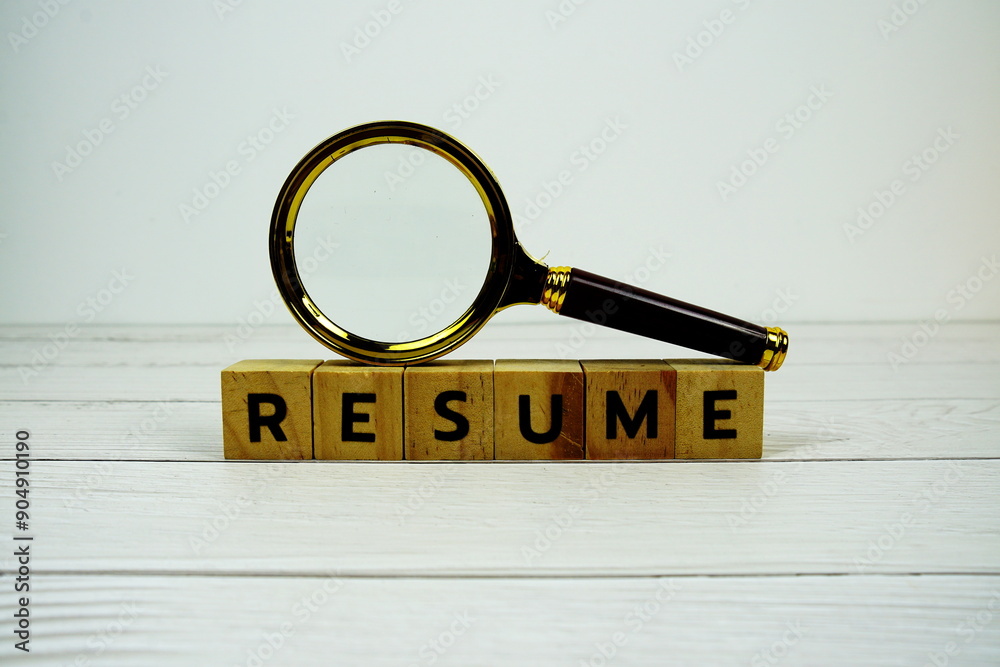 Resume with wooden blocks alphabet letters and Magnifying glass on ...
