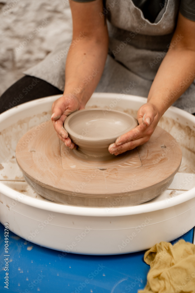 Wheel throwing. Learning how to model clay into different shapes with ...