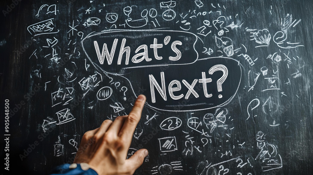 A hand points to the phrase "What's Next?" written on a blackboard ...