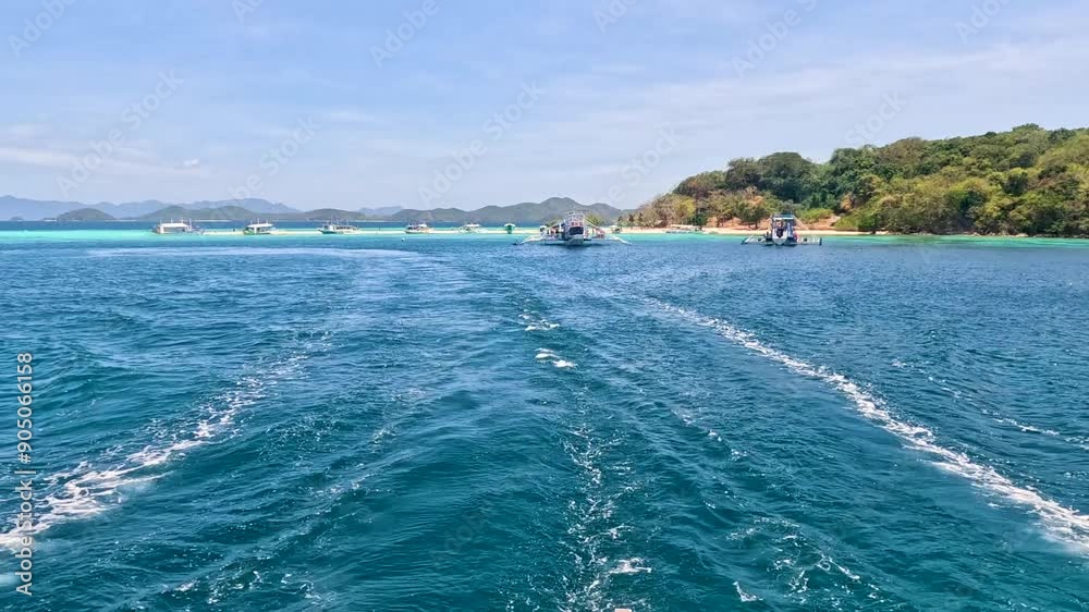 A view from behind a sailing boat as it sails from Coron to El Nido in ...