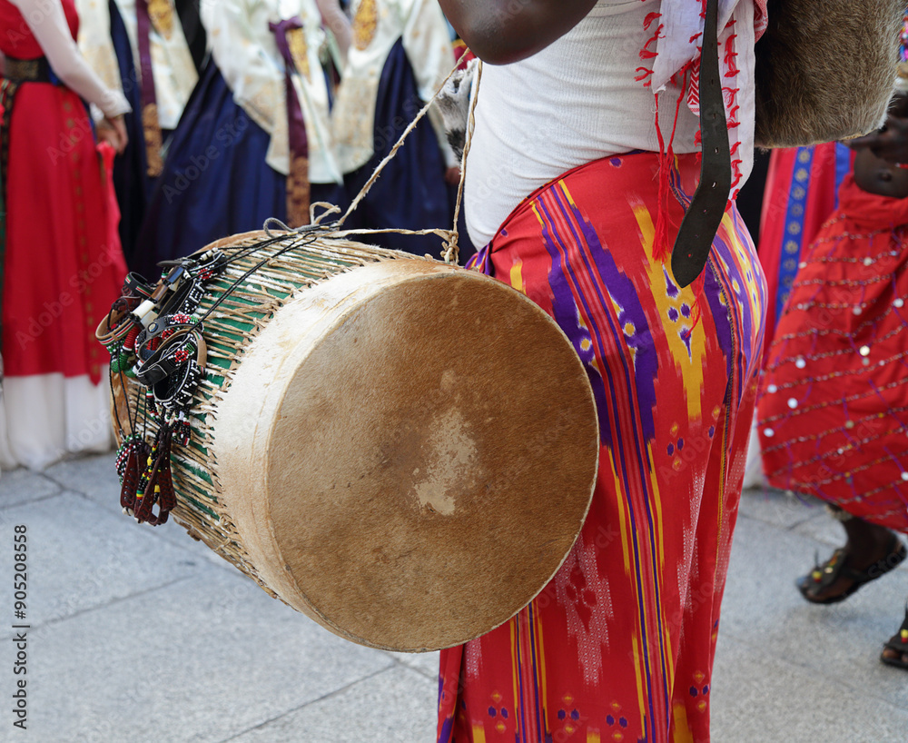 Man playing the drum and wearing one of the traditional costume of ...