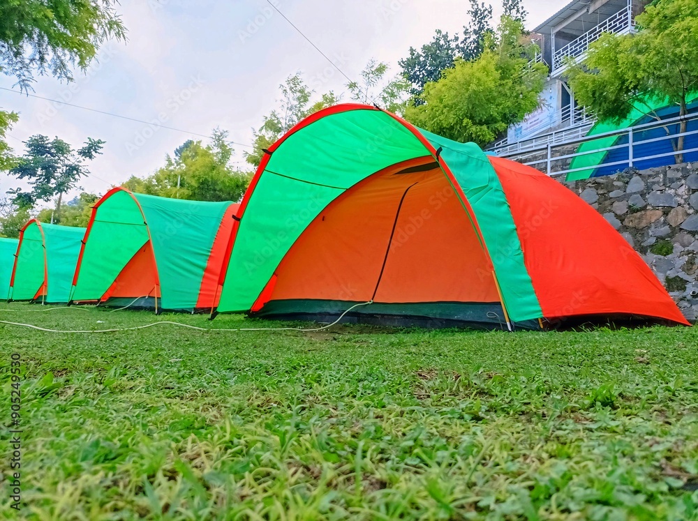 Campground filled with tents of various colors. Colorful camping tents ...