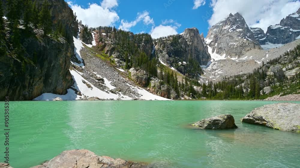 Stunning view of Delta Lake with a clear blue sky and rocky mountains ...