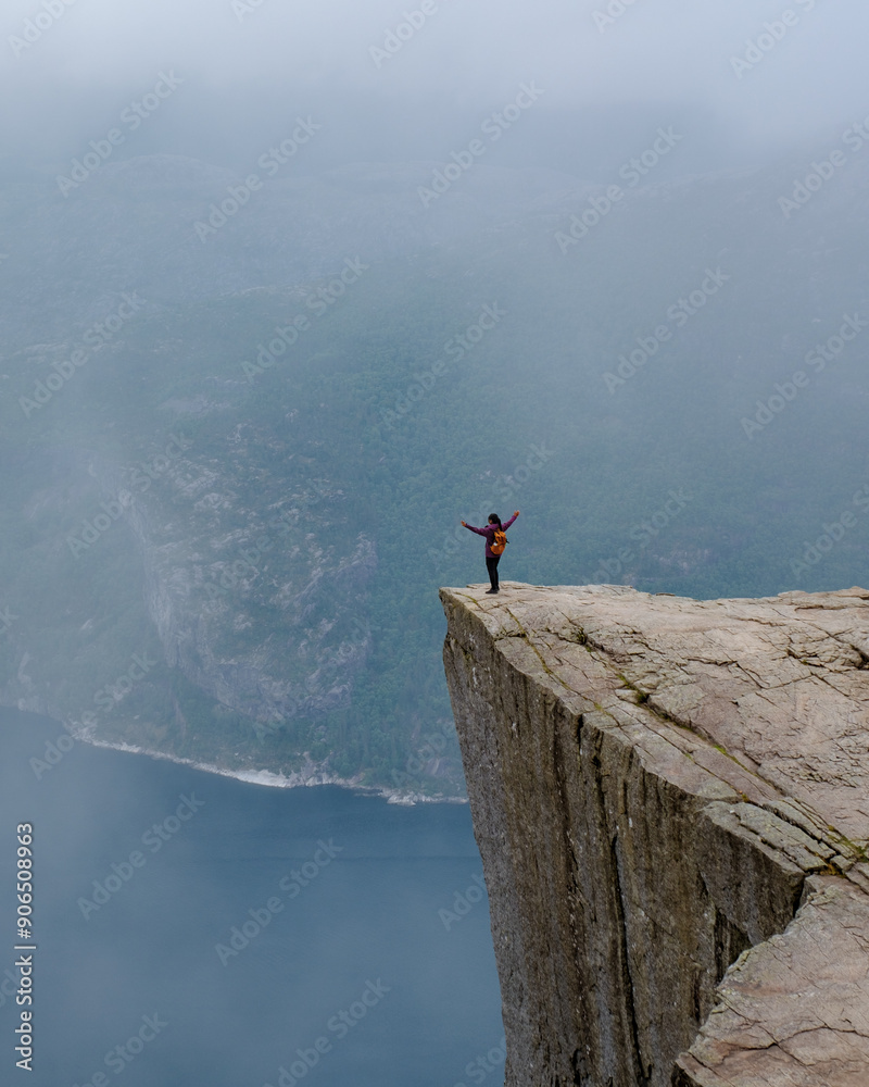 Daring Adventurer Standing on Pulpit Rock Overlooking Norway's Majestic ...