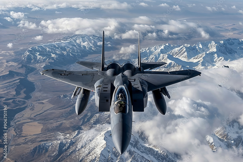 F-15 Eagle fighter jet soaring above snow-capped mountains, aerial view ...