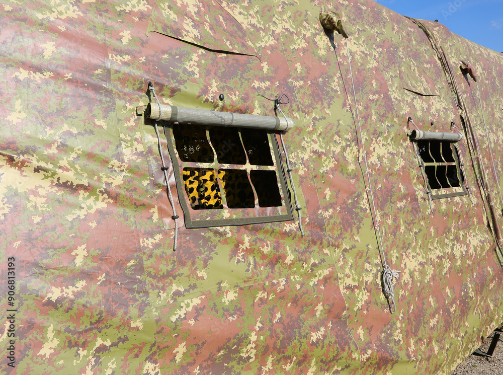 window of a military tent with camouflage fabric set up in a training ...