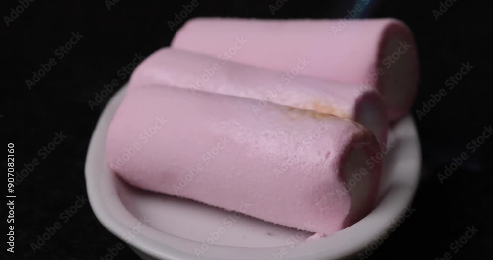 A blowtorch's flame intensifies, melting marshmallows in a mesmerizing ...