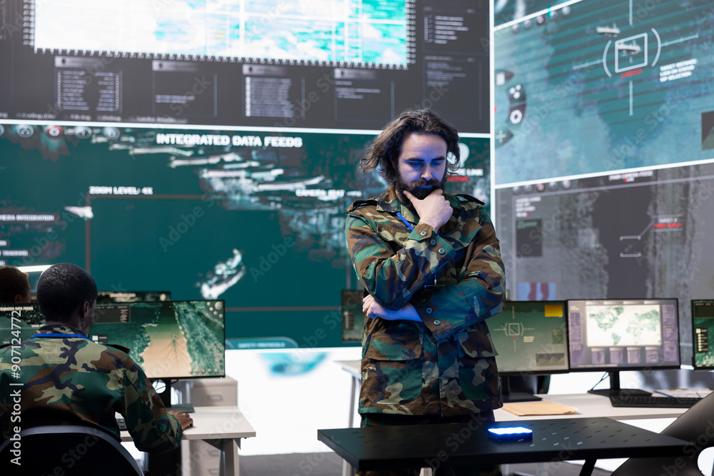 Military staff examining global satellite surveillance footage on a ...