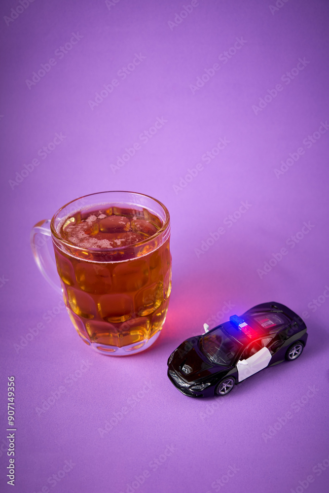 Toy police car with a jar of beer. Drunk driving concept and ...