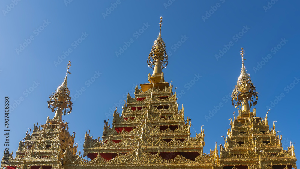 The spectacular roof of the temple against a clear blue sky. Pyramidal ...