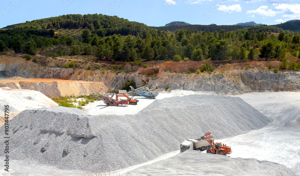 Load stones in opencast. Front end loaderlaying stones and Rubble ...