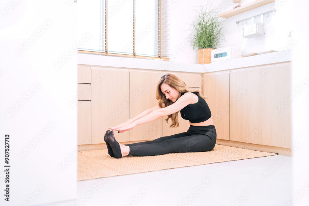 gorgeous woman warming seated bending forward. beautiful workout woman ...
