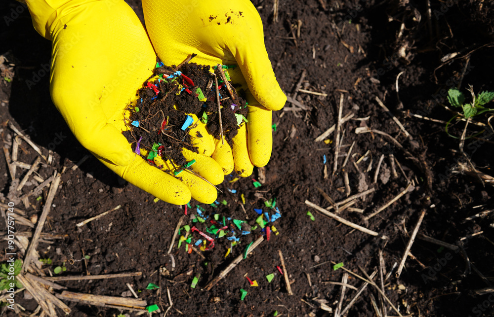 Microplastic pollution. Microplastics in ground. Soil contaminated with ...