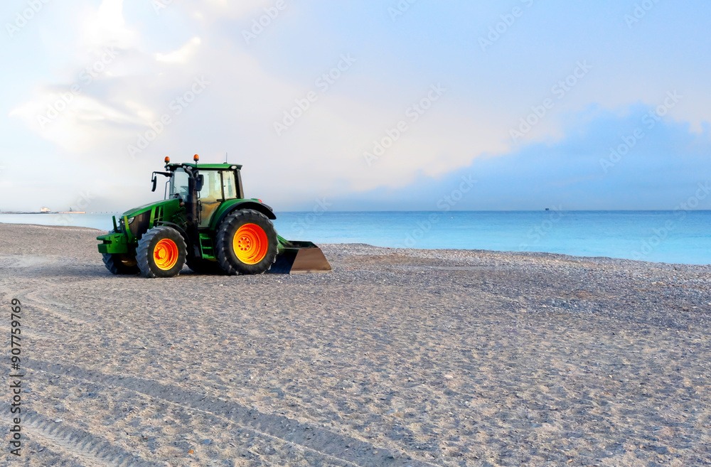 Clining beach and maintenance. Tractor grooming sand on beach shore in ...