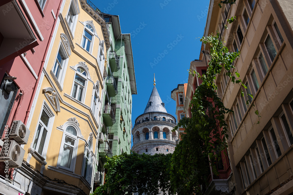 Galata Tower, one of the side streets of Beyoglu. Stone historical ...