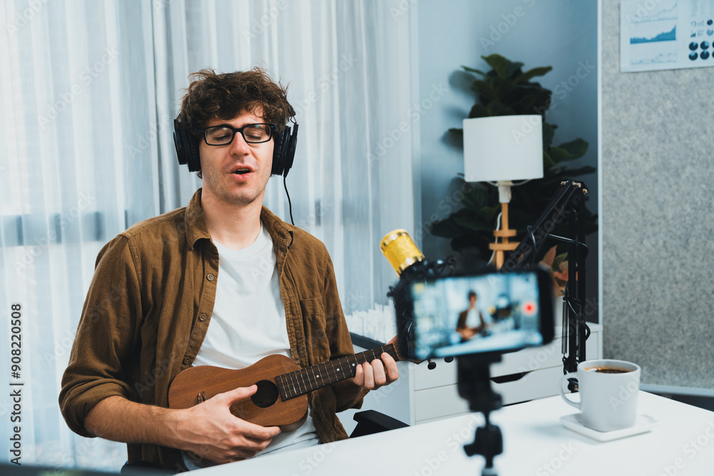 Host channel of influencer singing with playing guitar on blurred phone ...