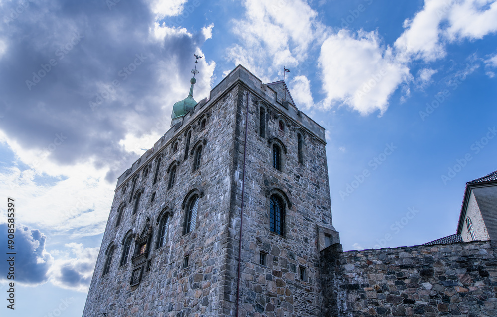 A stone pathway leads through a grand, arched gate towards the historic ...