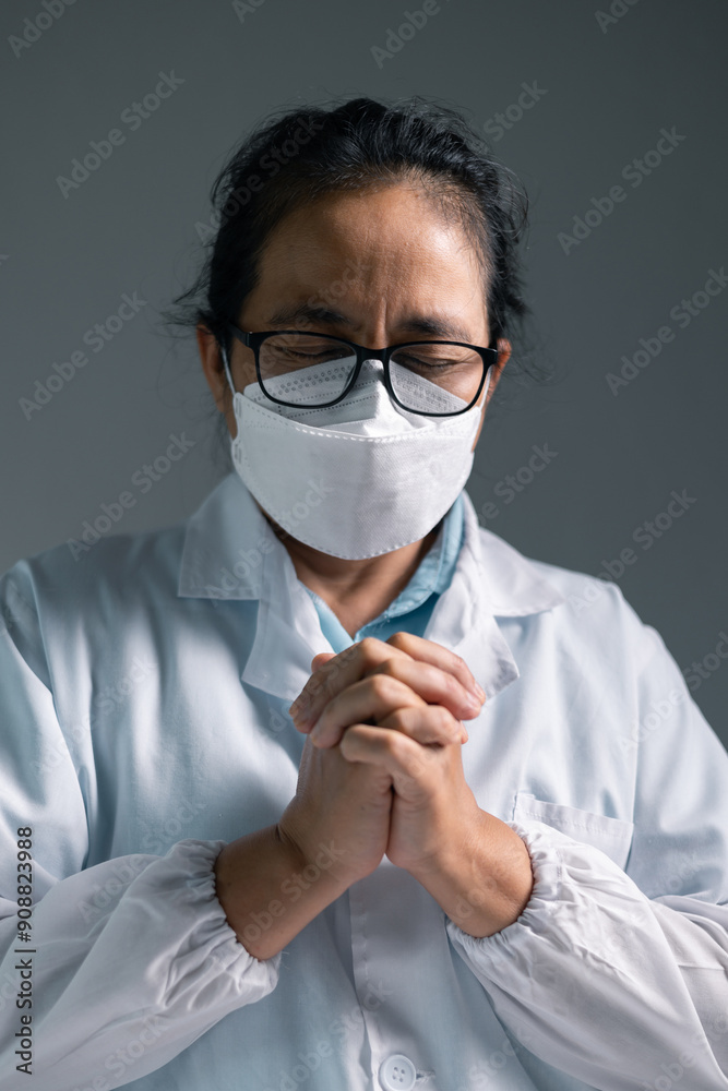 Doctor clasped their hands in prayer, hoping for the best as they ...