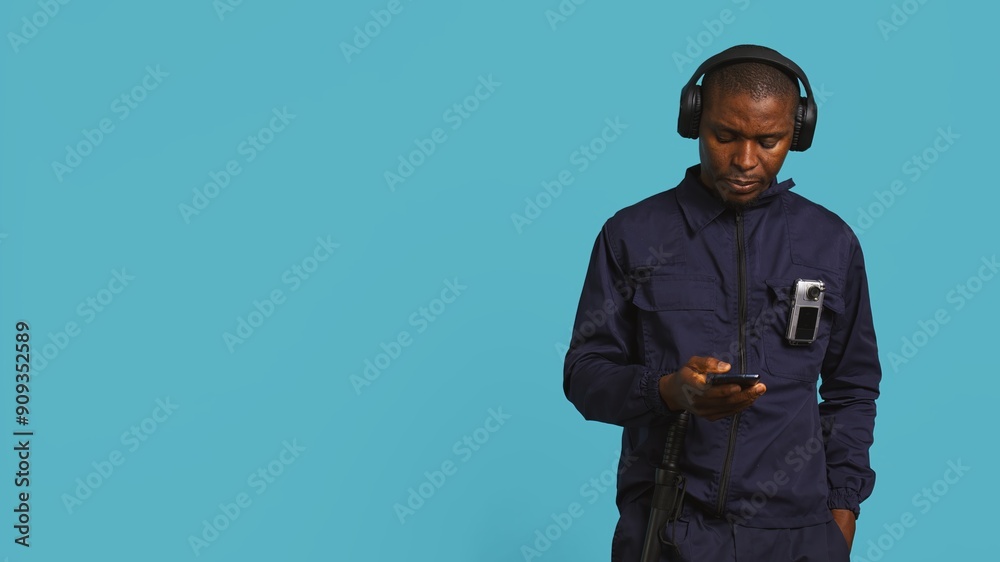 Security guard equipped with bodycam listening music, taking break from ...