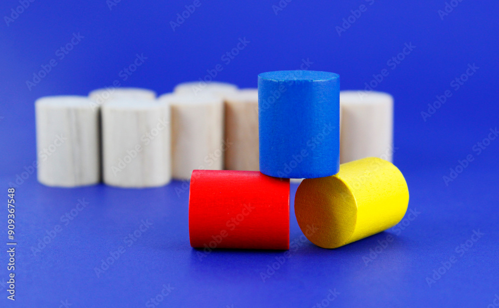 Poster Wooden cylinders with primary colors that are differentiated ...