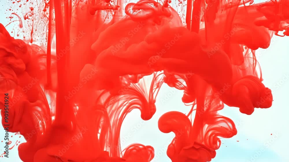 Close-up: Vibrant red paint erupts across pristine white canvas. High ...